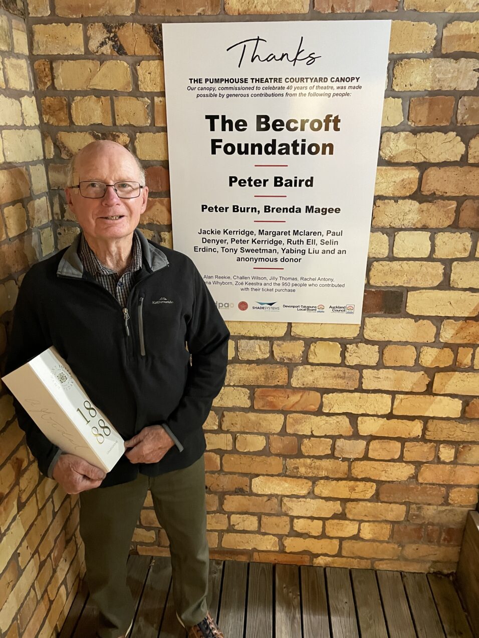 Peter Baird next to the donor acknowledgement panel - The PumpHouse Theatre